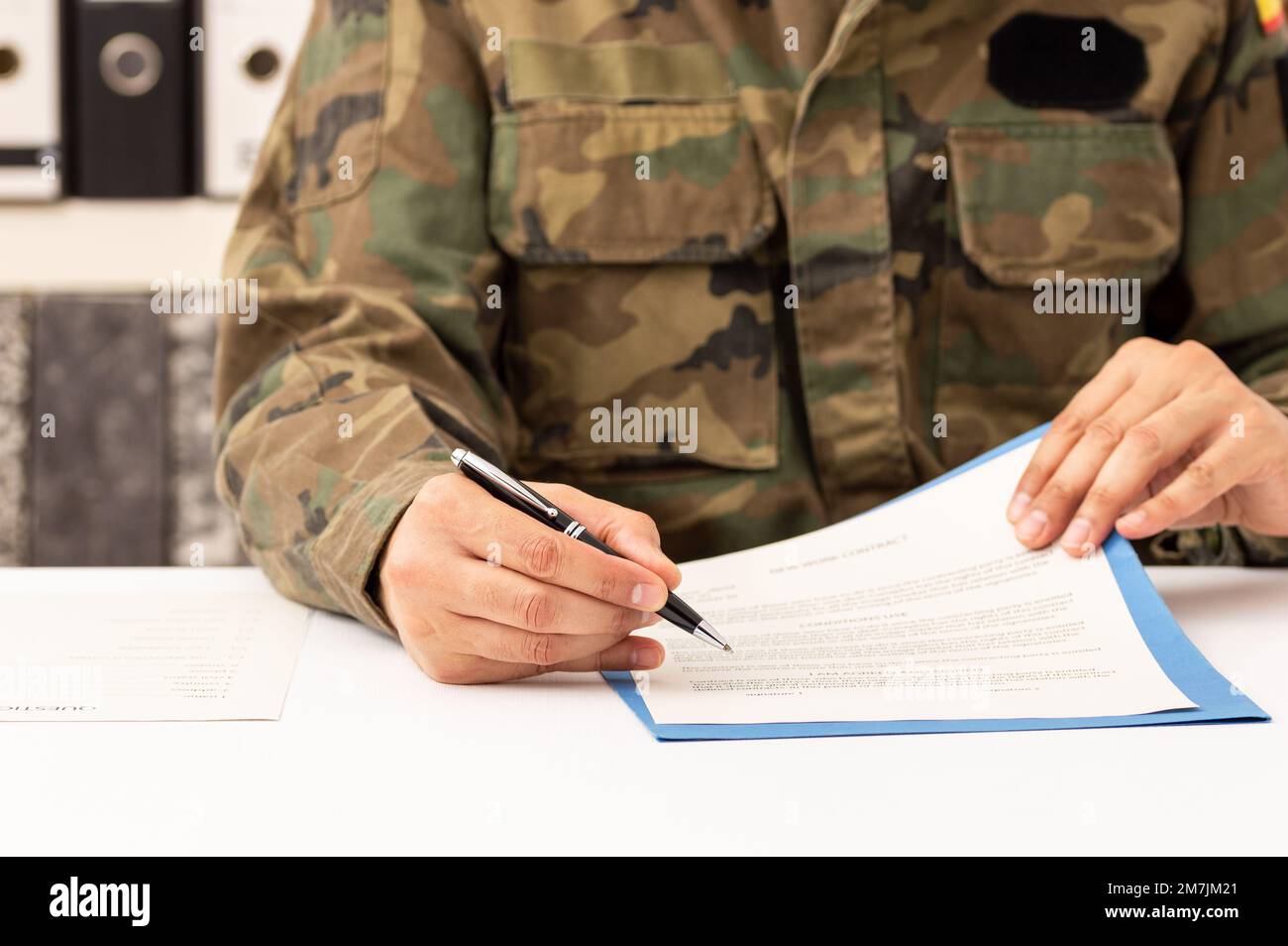 Close up of executive military man hands signing contract on a desk at ...
