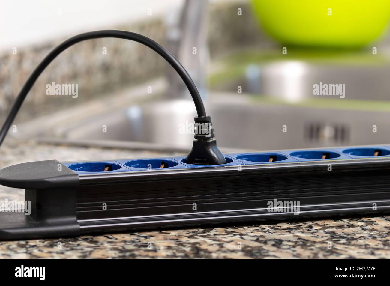 Close up of a dangerous damaged electrical cord a tabletop at kitchen ...