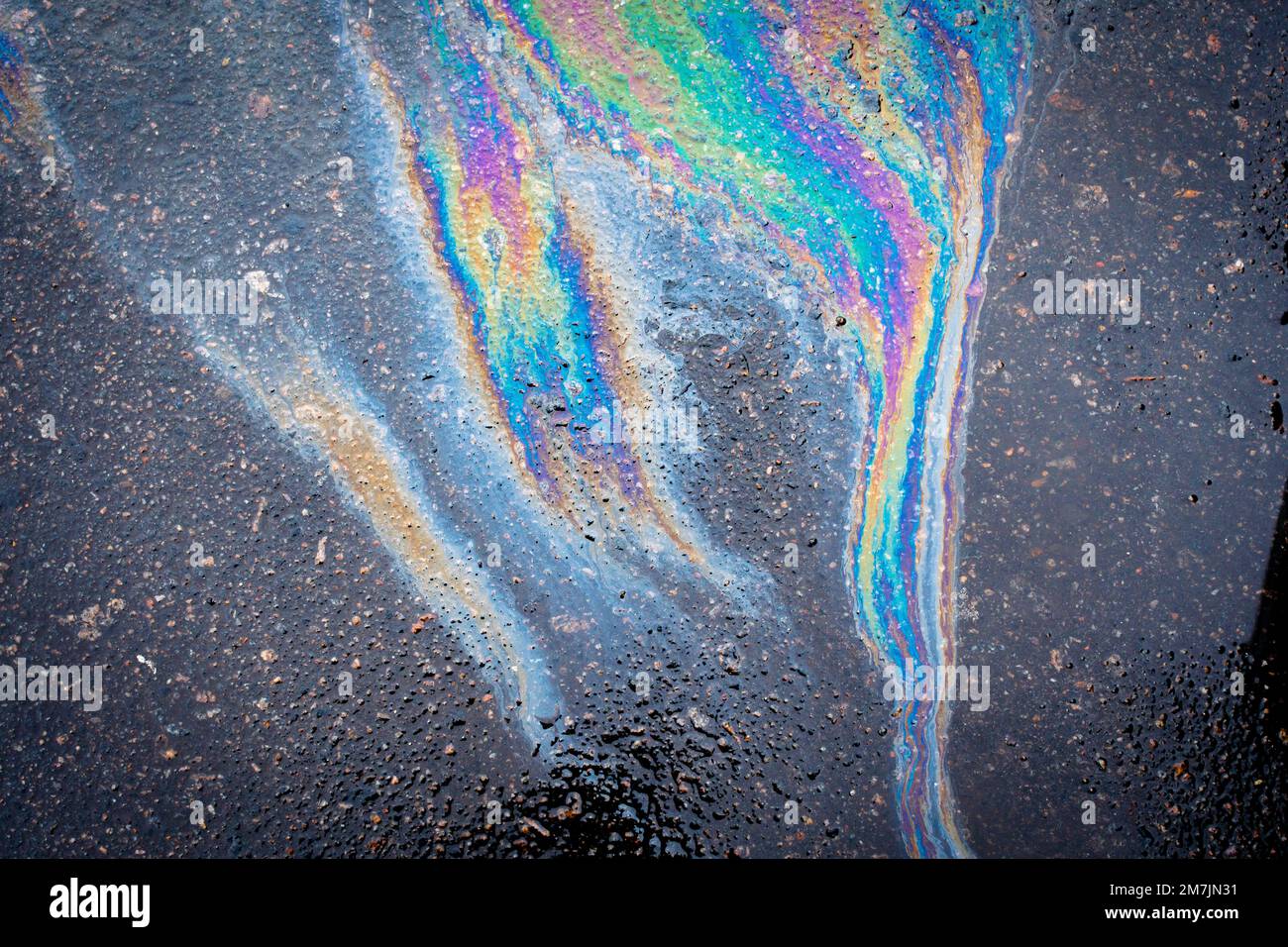Abstract background from motor oil, gas or petrol spilled on asphalt ...