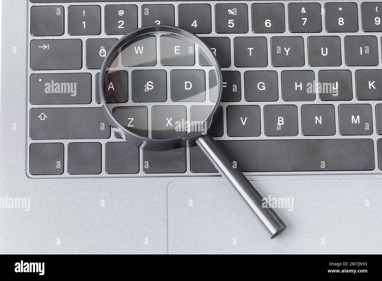 Magnifying glass on laptop. Internet search concept Stock Photo - Alamy