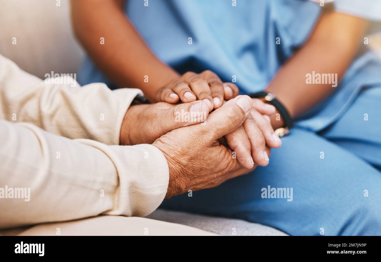 Nurse, patient and holding hands in nursing home for healthcare, empathy and support in ...