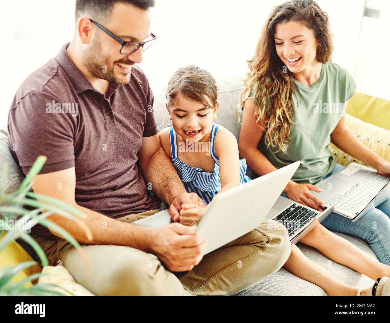 child laptop family computer woman mother father happy home man ...