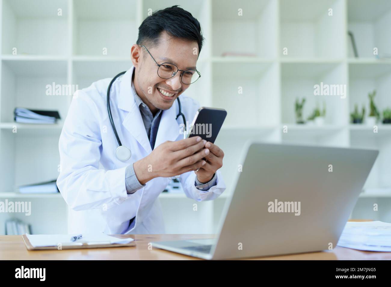 Portrait of a doctor looking at a patient's information before treating ...