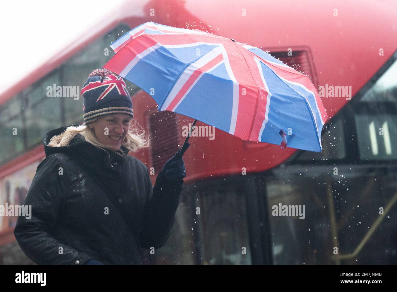 A woman walks near Westminster Bridge, central London in the rain. The ...