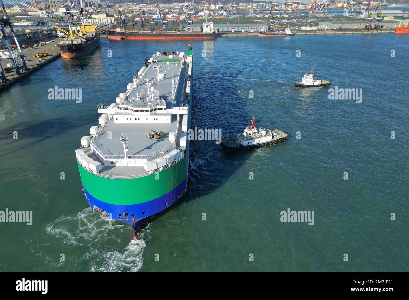 YANTAI, CHINA - JANUARY 10, 2023 - A car ro-ro ship, assisted by ...