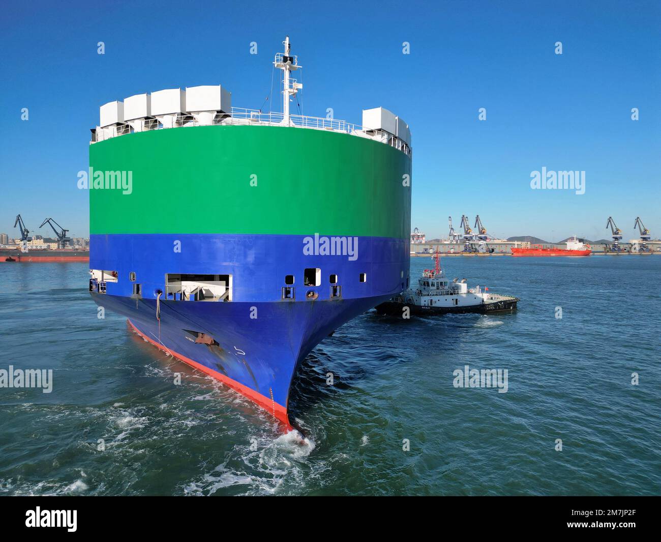 YANTAI, CHINA - JANUARY 10, 2023 - A car ro-ro ship, assisted by ...