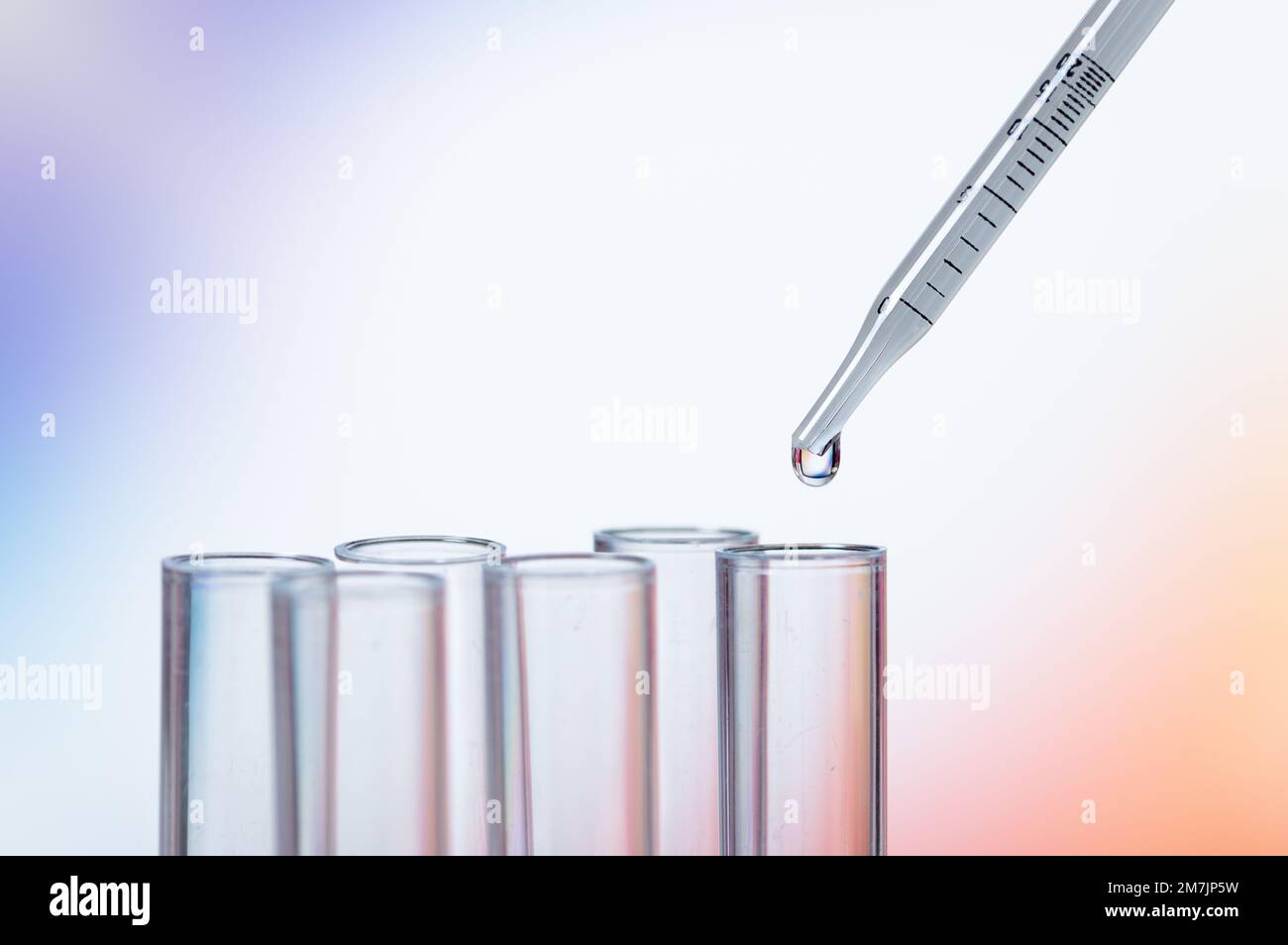 Close-up of pipette dropping a sample into a test tube Stock Photo - Alamy