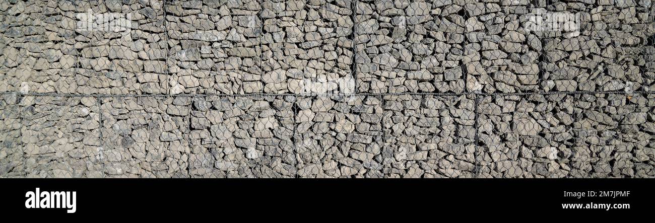grey stone and pebbles in wire mesh wall horizontal stones facade ...