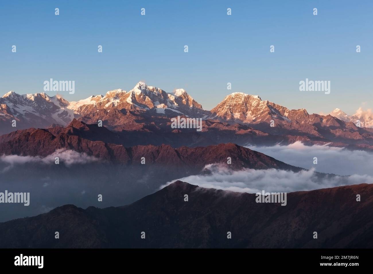 Beautiful mountain landscape with amazingly floating clouds at sunrise ...
