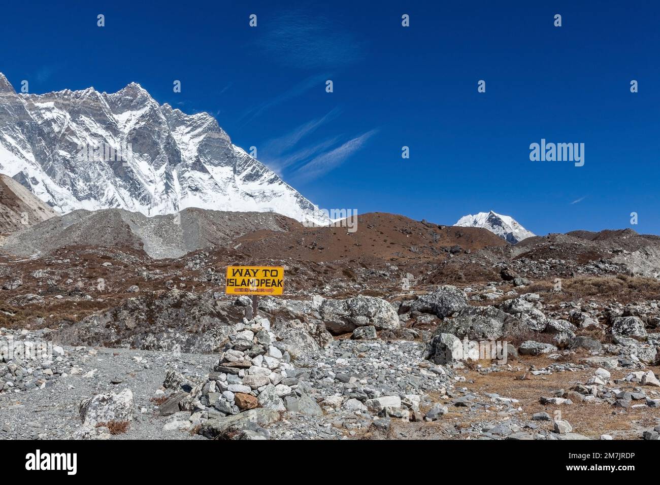 Way to Island Peak sign installed on a rocky trail with Lhotse mountain ...