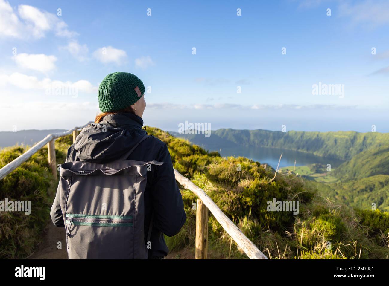 Rear view of a woman looking at the scenic views of São Miguel island ...