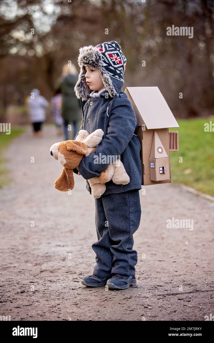 Little child, blond boy with pet dog, carying home on his back, kid ...