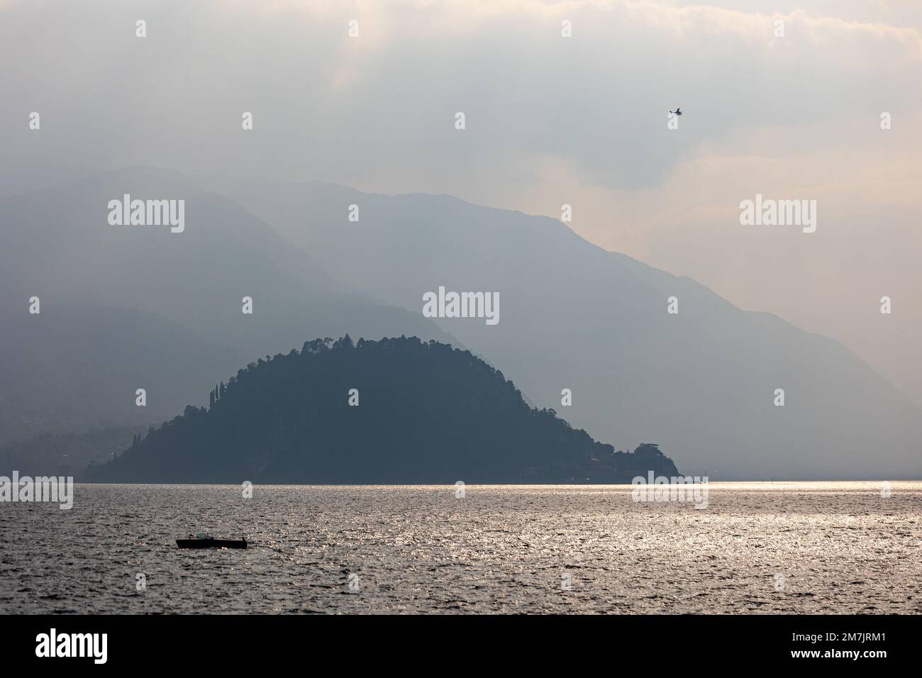 Dramatic Light Rays Over Lake Como, Italy with Islands and Hills in the ...