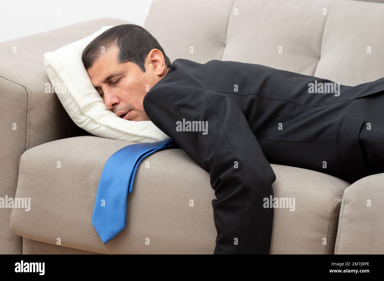 Businessman resting on a sofa hi-res stock photography and images - Alamy