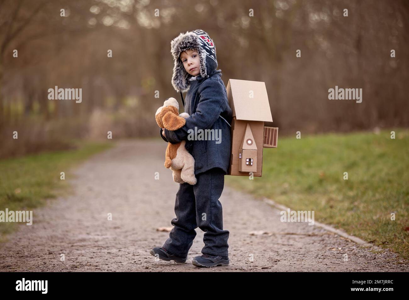 Little child, blond boy with pet dog, carying home on his back, kid ...