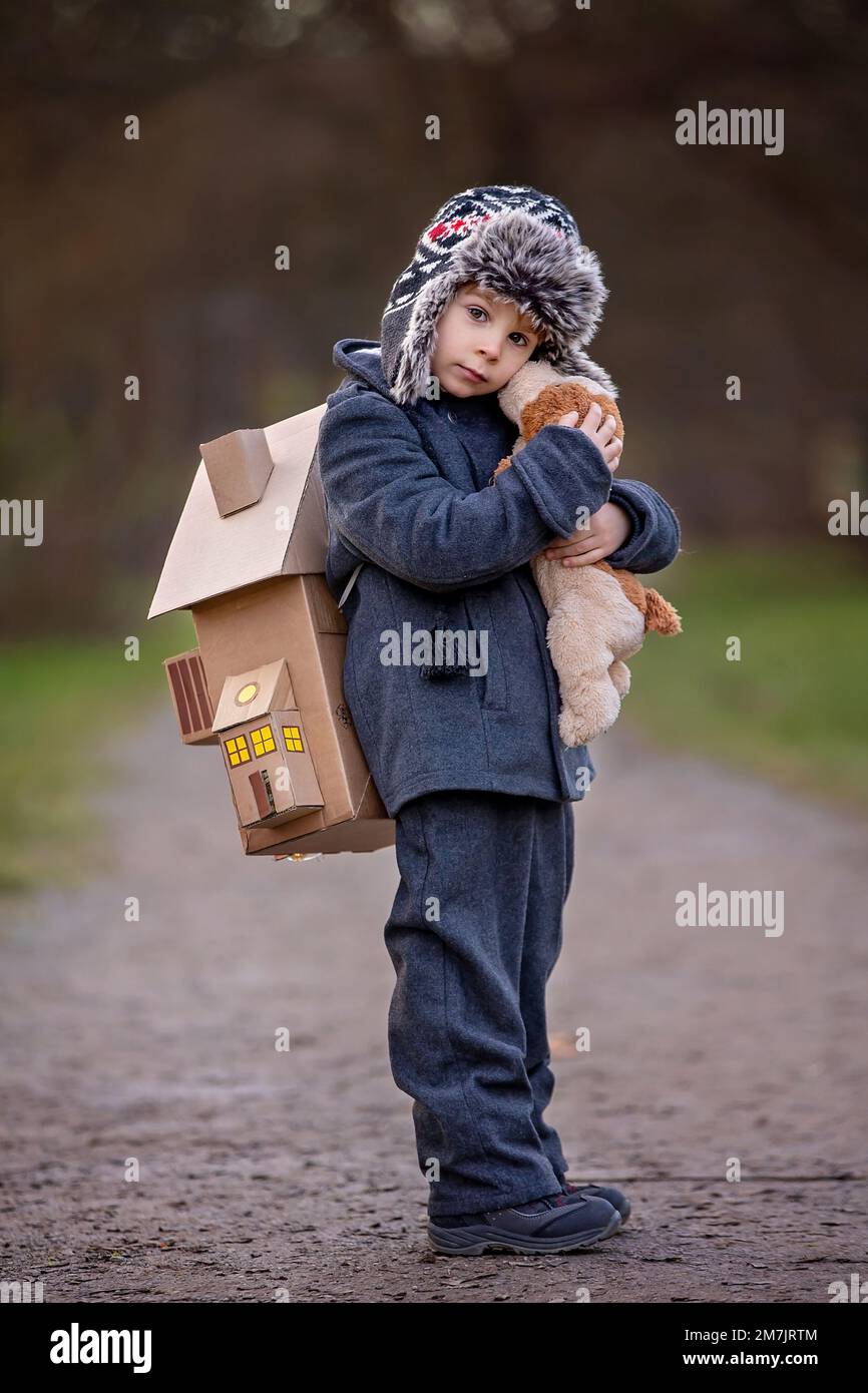 Little child, blond boy with pet dog, carying home on his back, kid ...