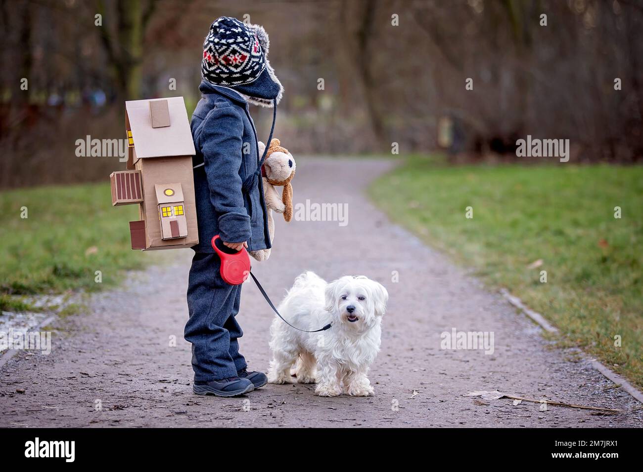 Little child, blond boy with pet dog, carying home on his back, kid ...