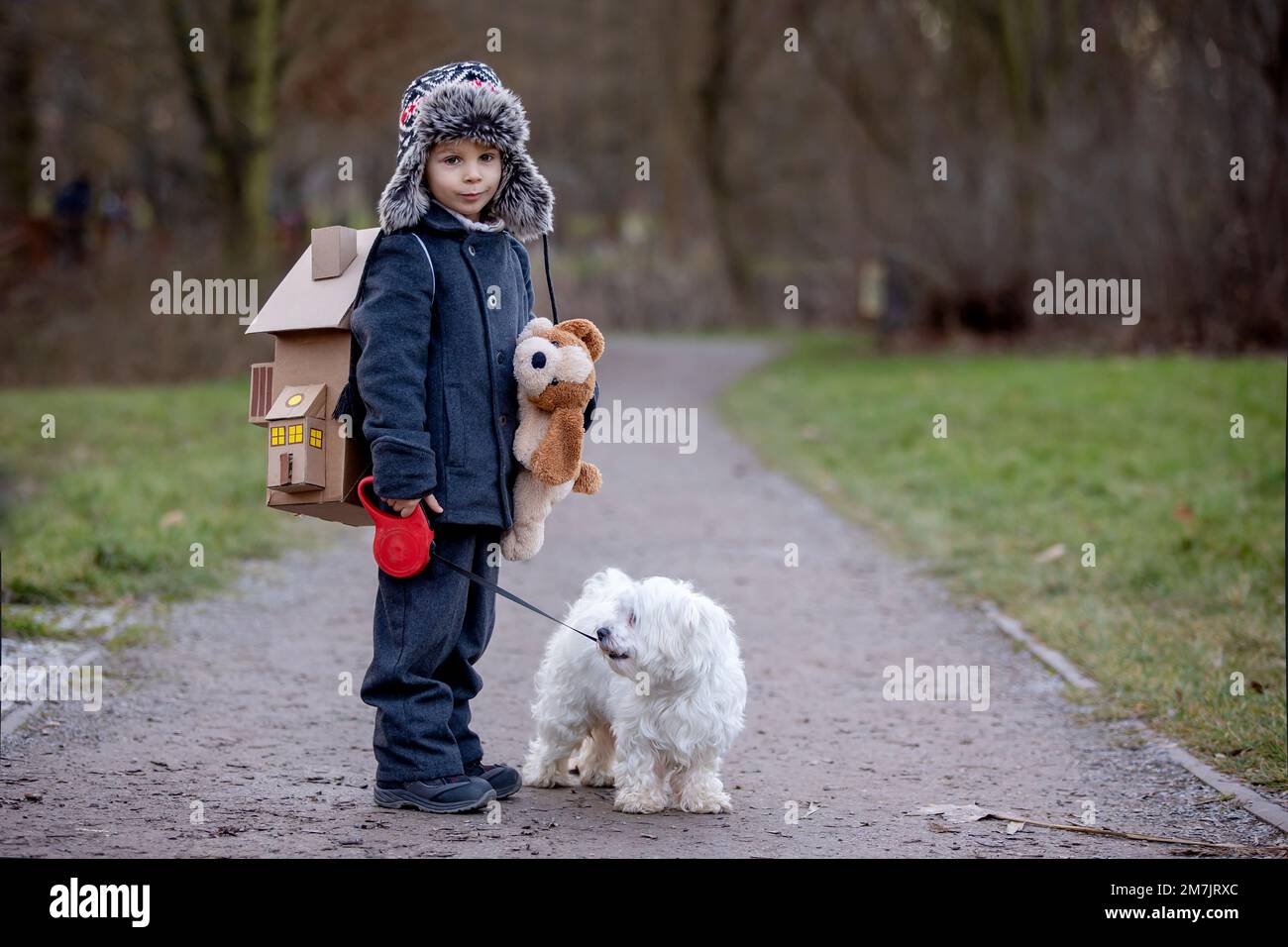 Little child, blond boy with pet dog, carying home on his back, kid ...