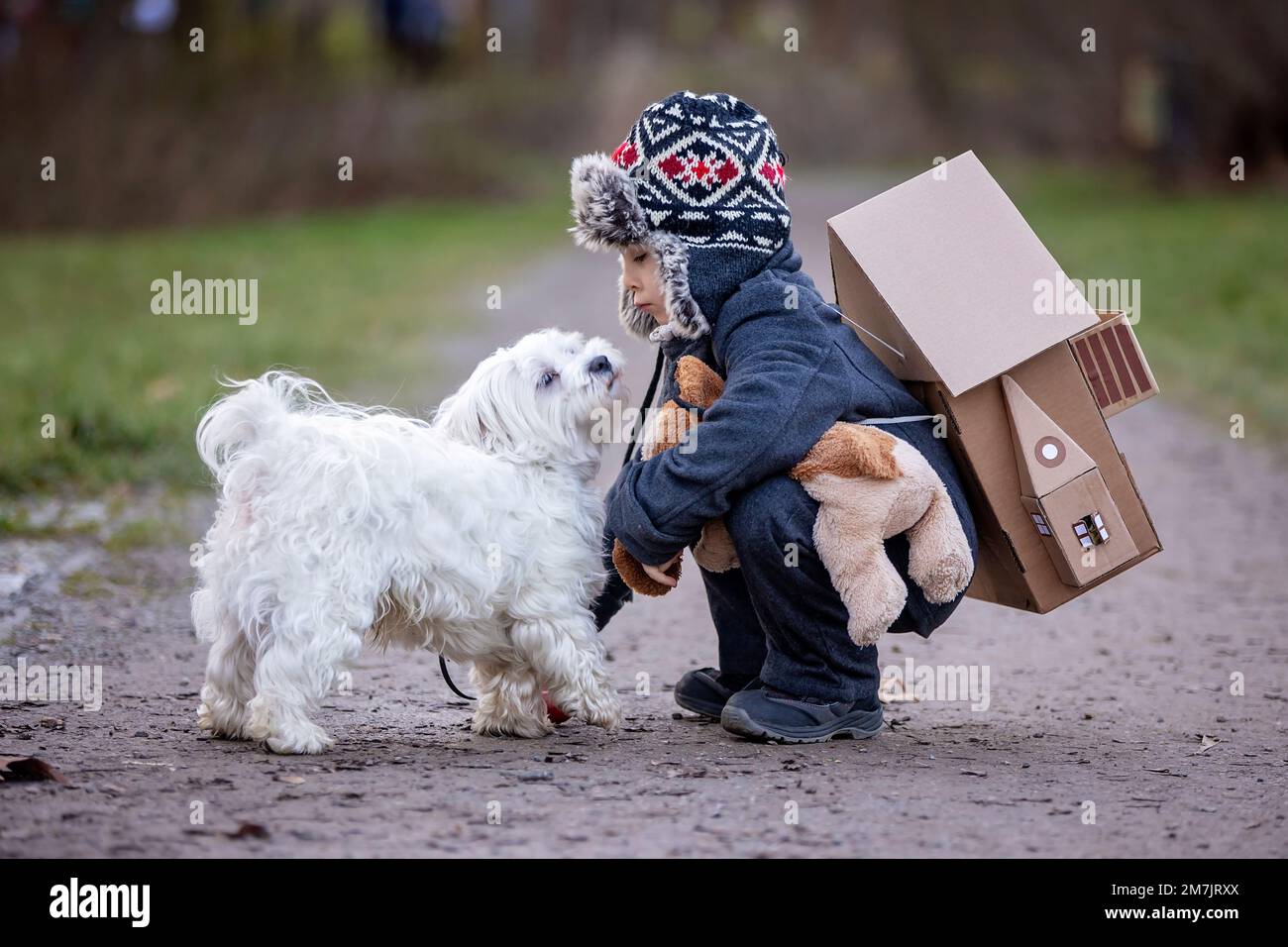Little child, blond boy with pet dog, carying home on his back, kid ...