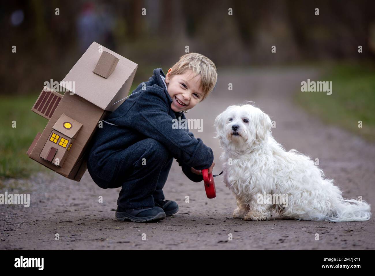 Little child, blond boy with pet dog, carying home on his back, kid ...