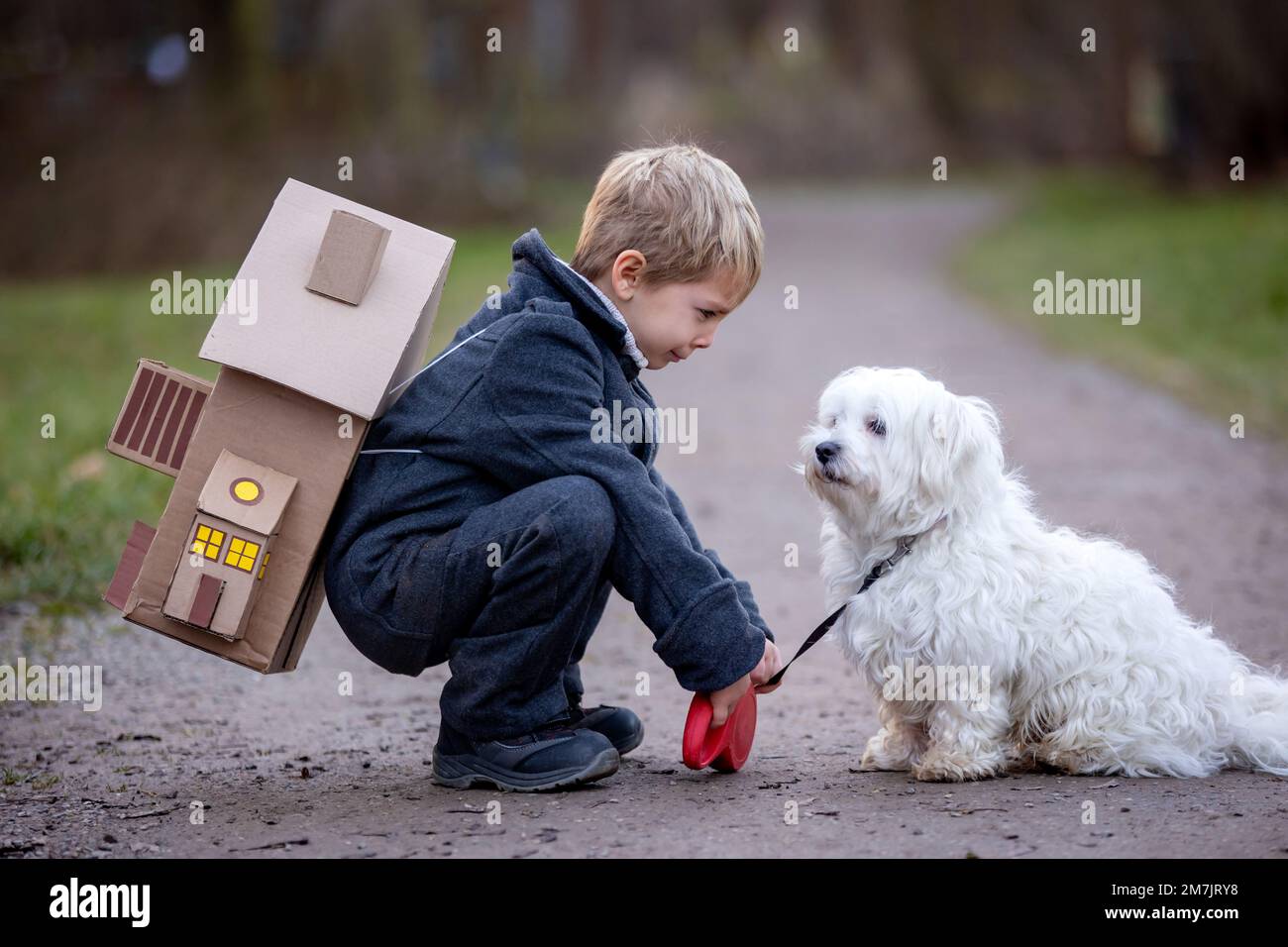 Little child, blond boy with pet dog, carying home on his back, kid ...