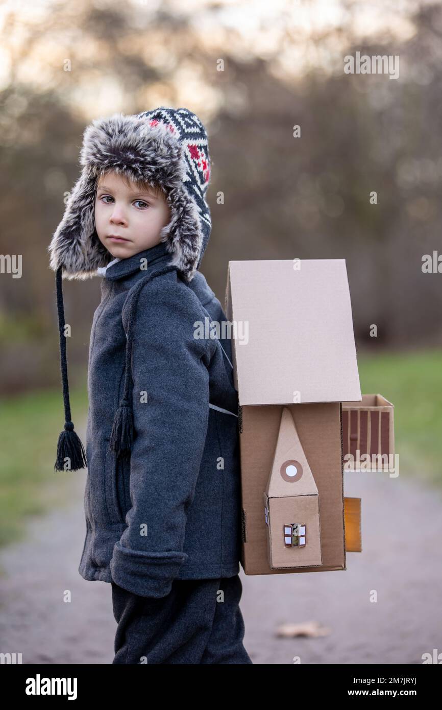 Little child, blond boy with pet dog, carying home on his back, kid ...