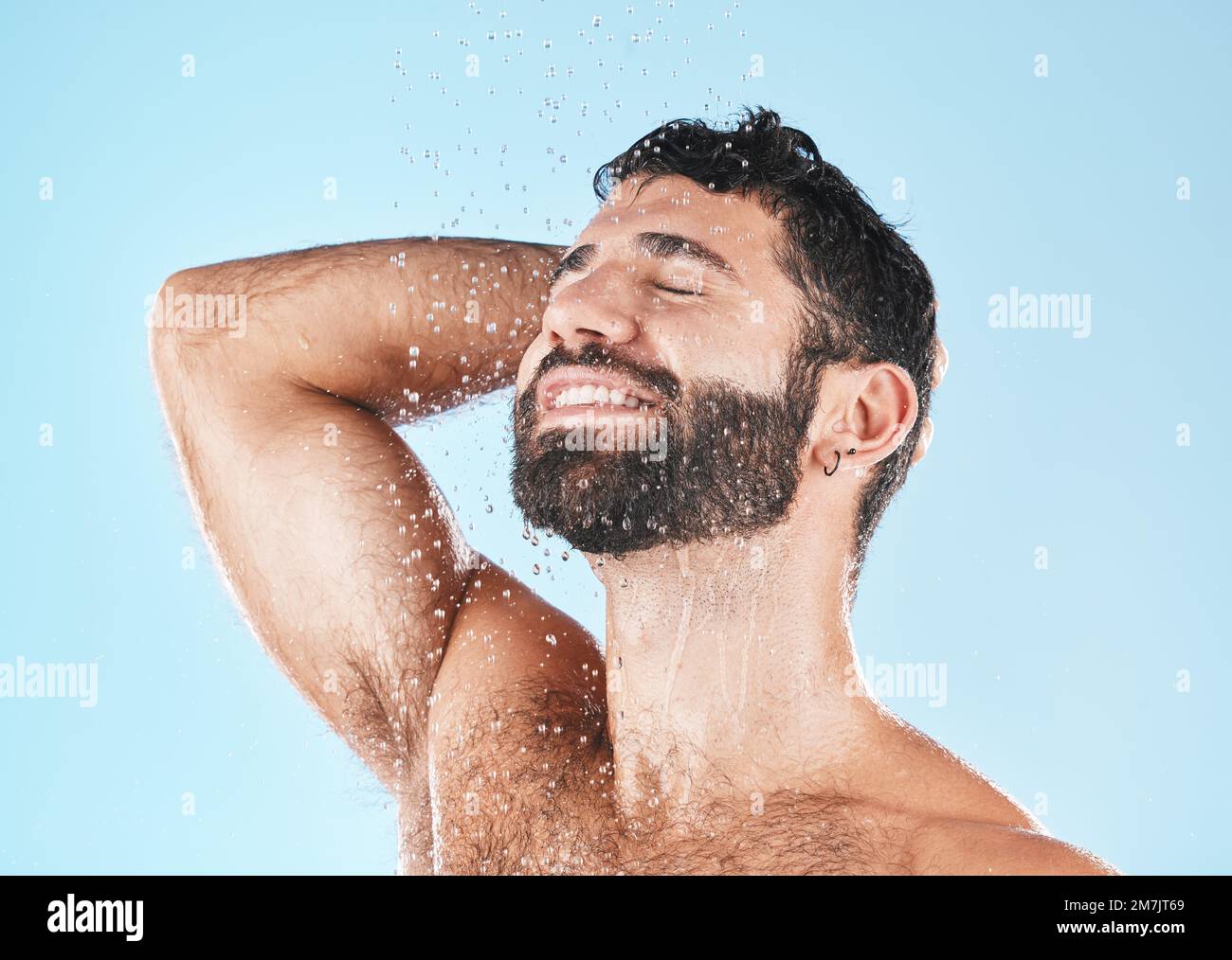 Shampoo, shower and cleaning with a model man washing his hair in ...