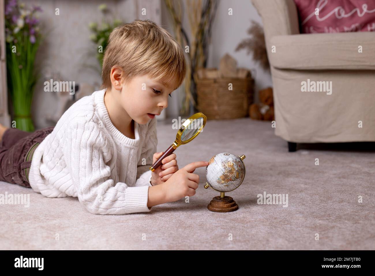 Cute little toddler blond child, boy, exploring world globe with ...