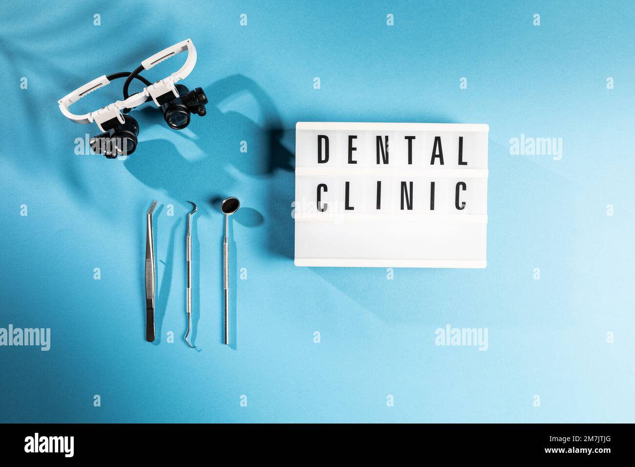 Dental Clinic sign on Blue Background Stock Photo - Alamy