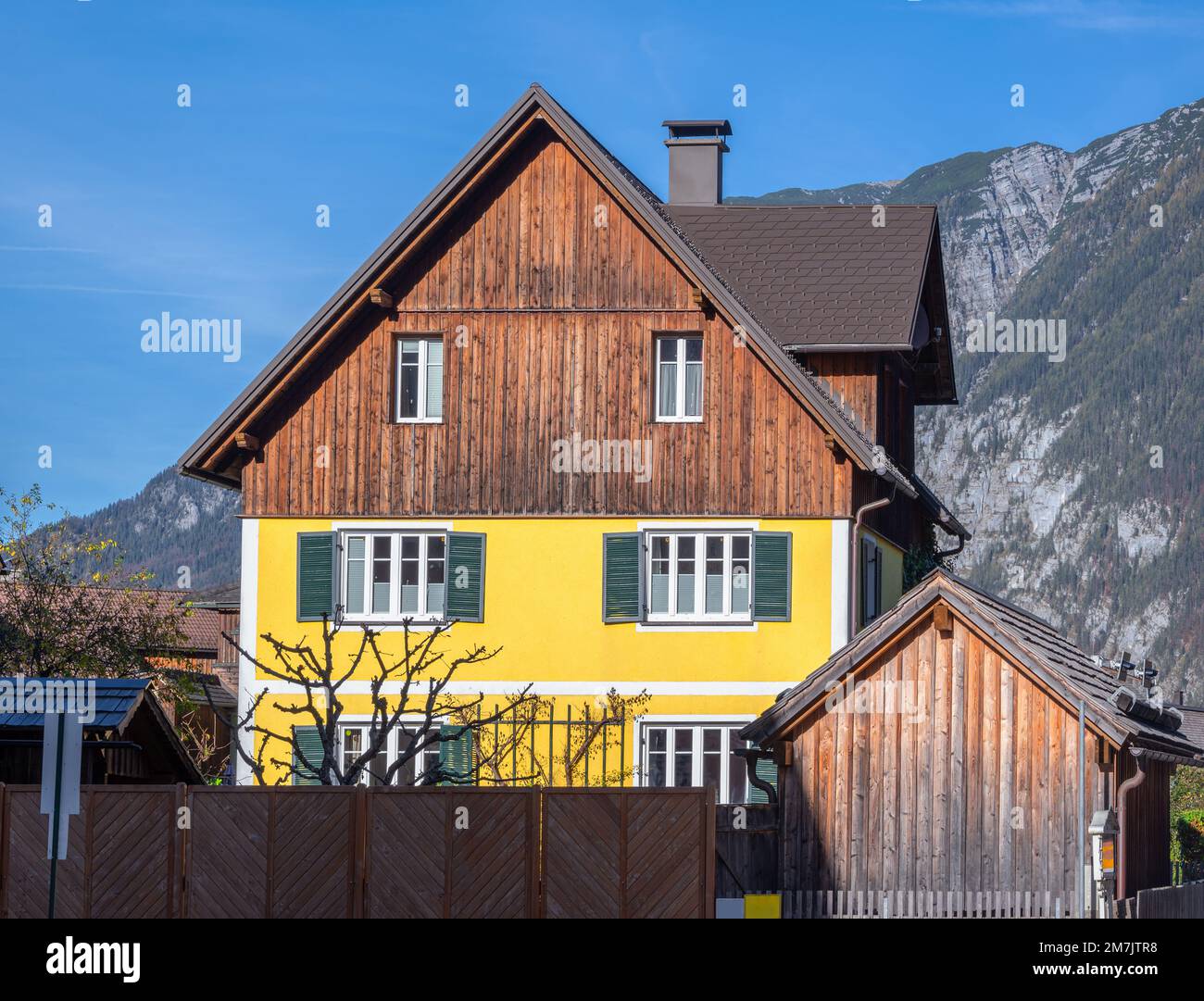 View of a wooden chalet alpine house situated at the salt mine village ...
