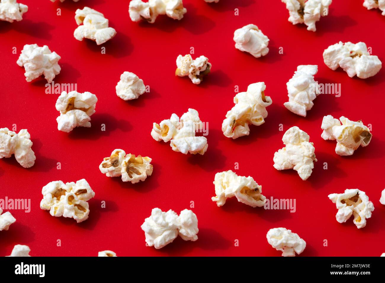 Popcorn pattern on red background with hard shadow Stock Photo - Alamy