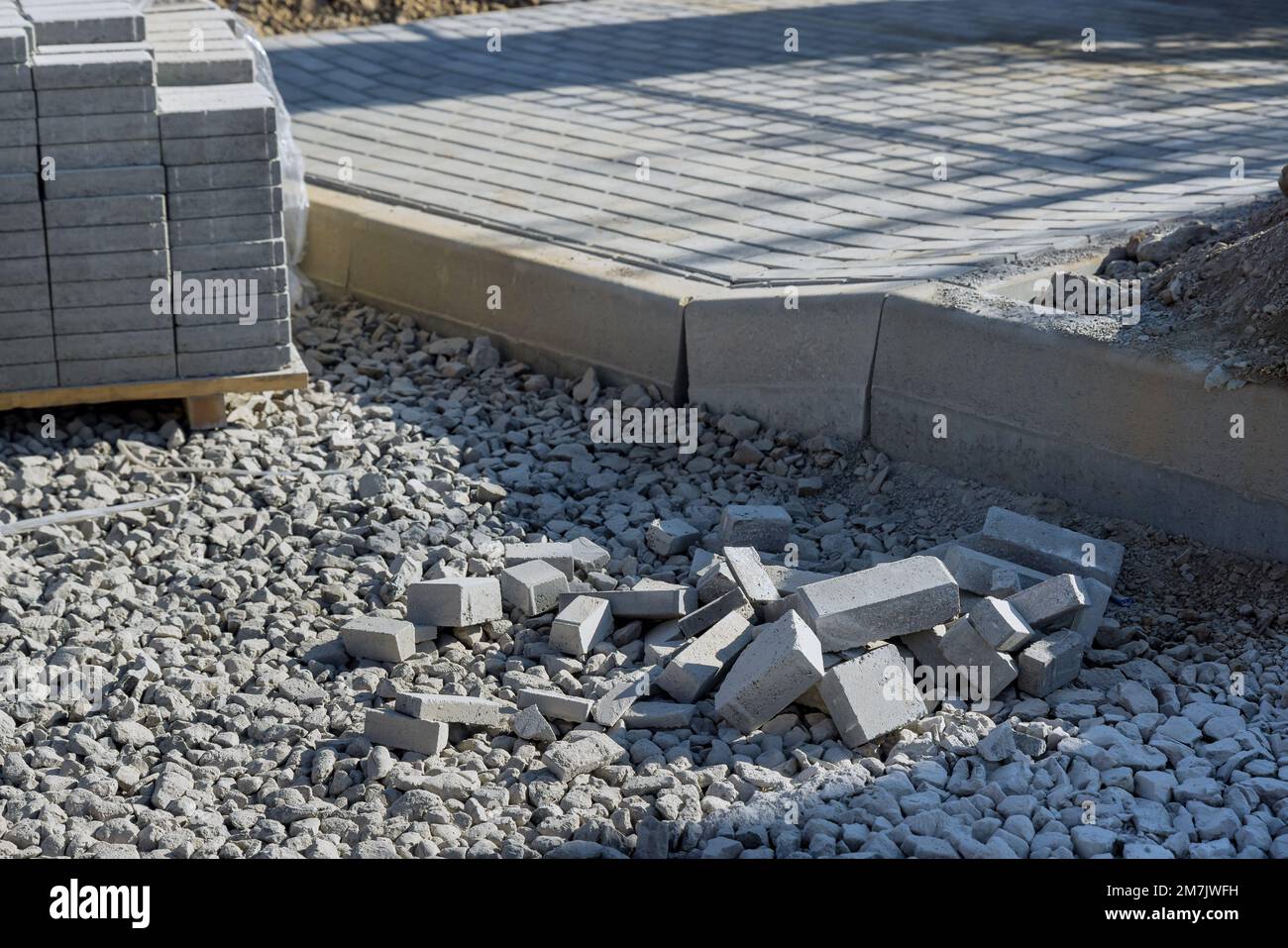 Preparation for laying gray concrete brick on pavement landscaping ...