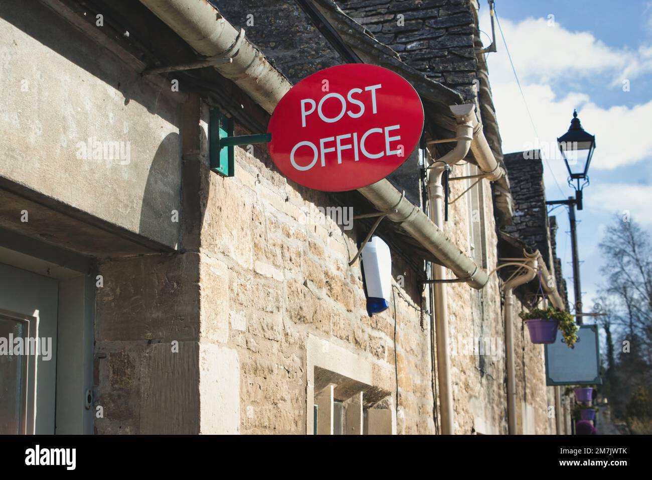 Building exterior showing a red post office sign in a rural village in ...