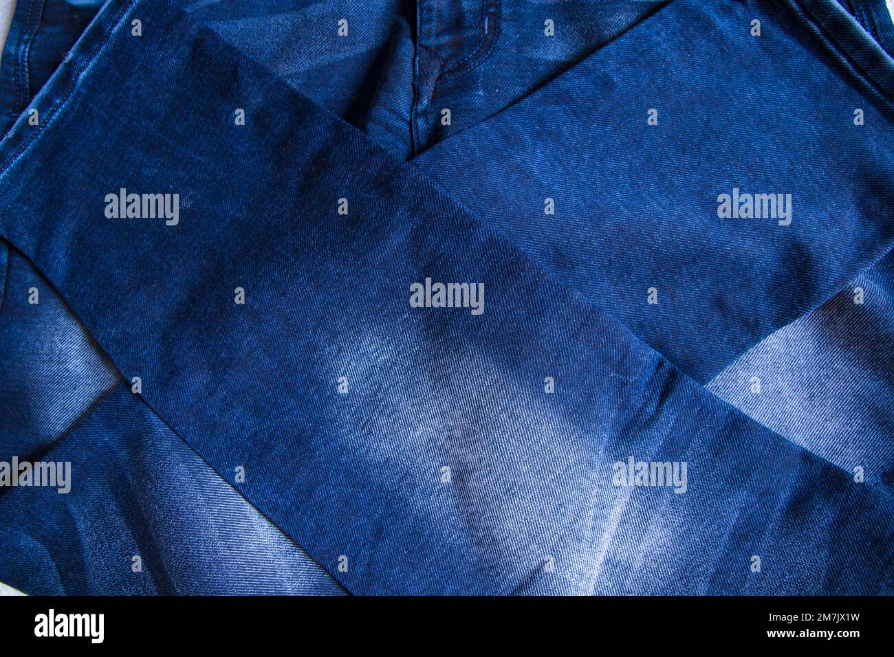 folded blue jeans pant pattern texture background Stock Photo - Alamy