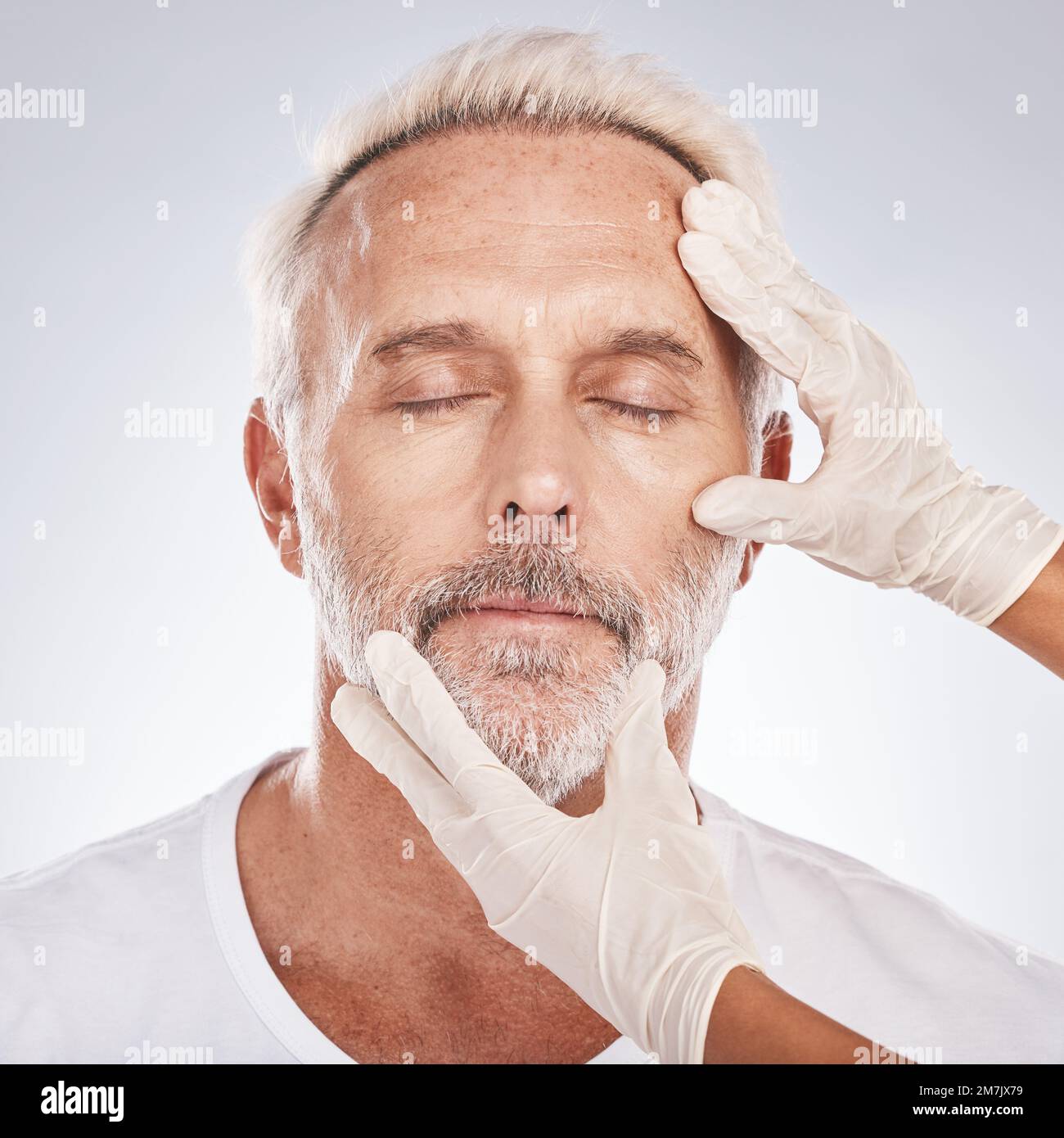 Man, face or plastic surgeon hands on studio background for skincare ...