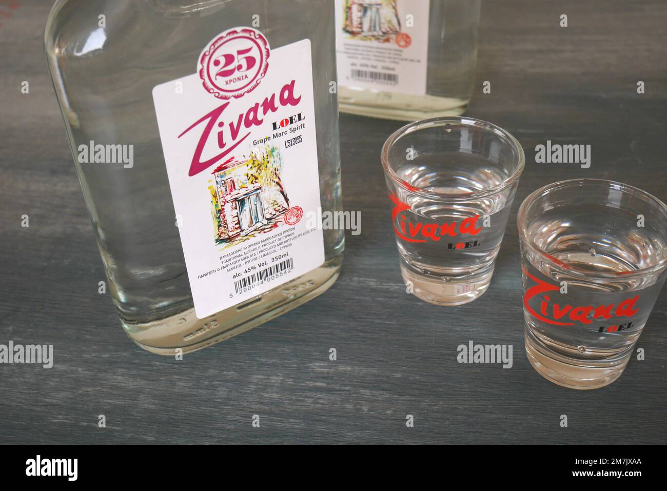 Two bottles and glasses of Cypriot spirit drink Zivana Stock Photo - Alamy
