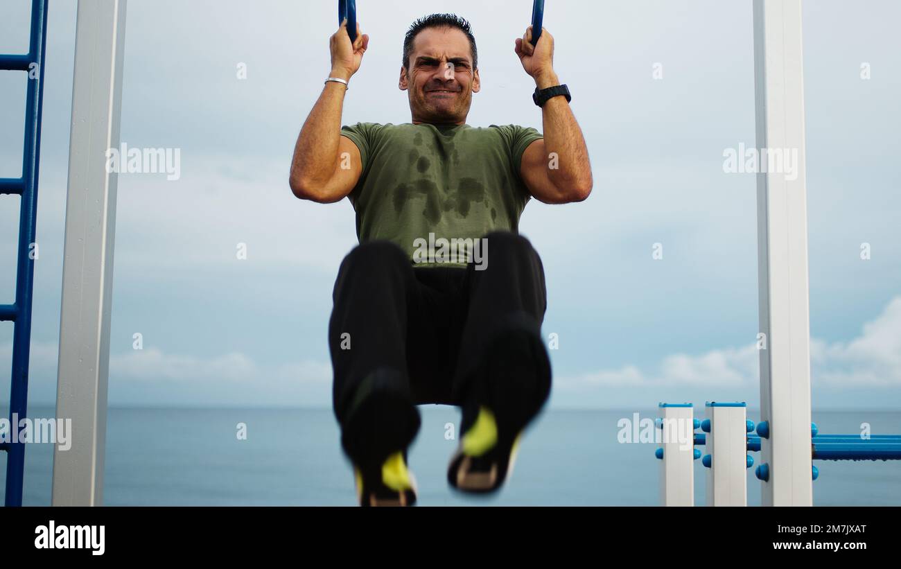 Abs Workout Exercise On Rings Stock Photo - Alamy