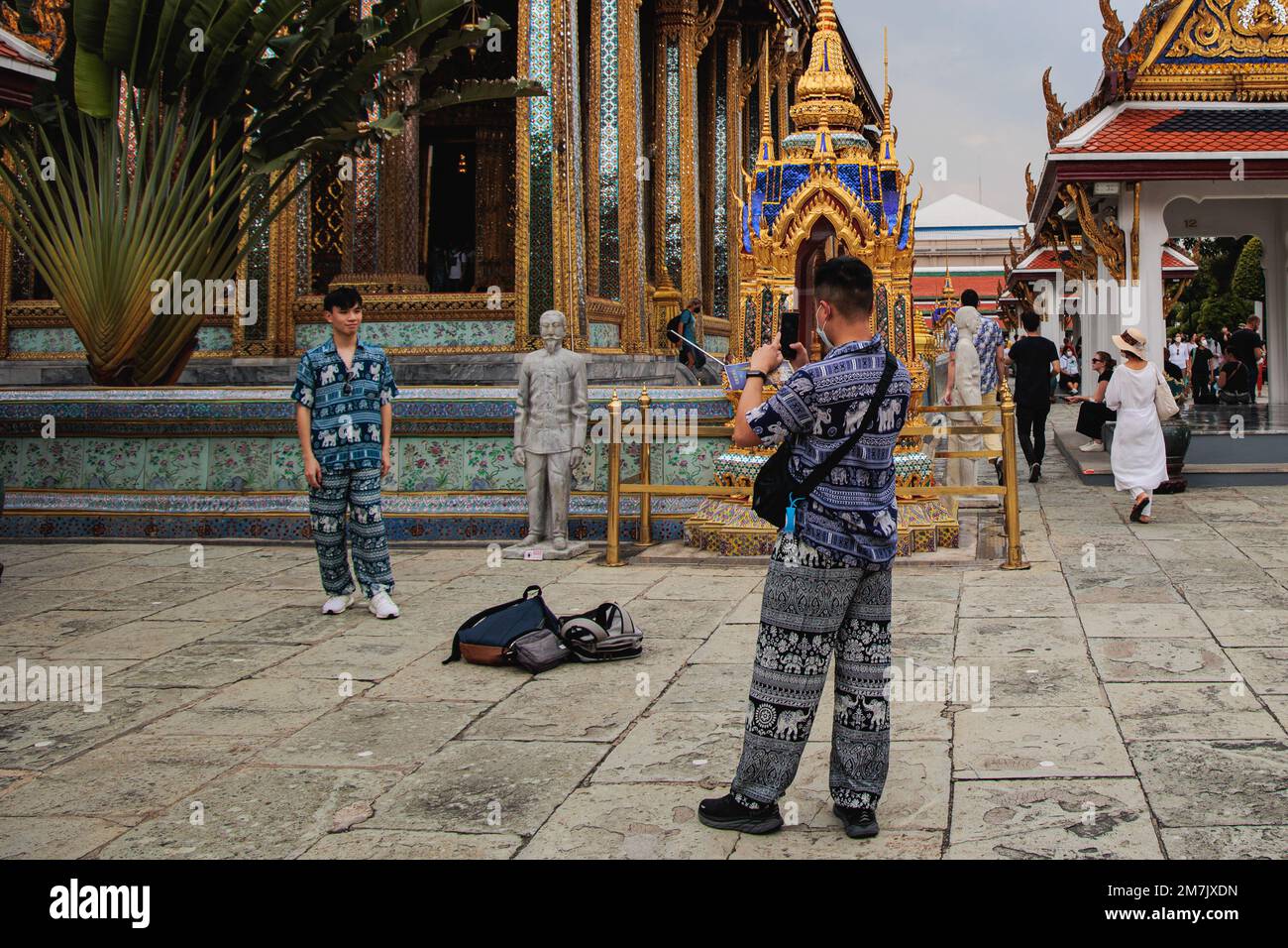Tourists take photos at The Grand Palace in Bangkok. The Grand Palace ...