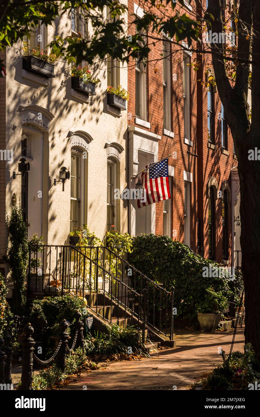Residential street with American flags in Georgetown, a plush, historic ...