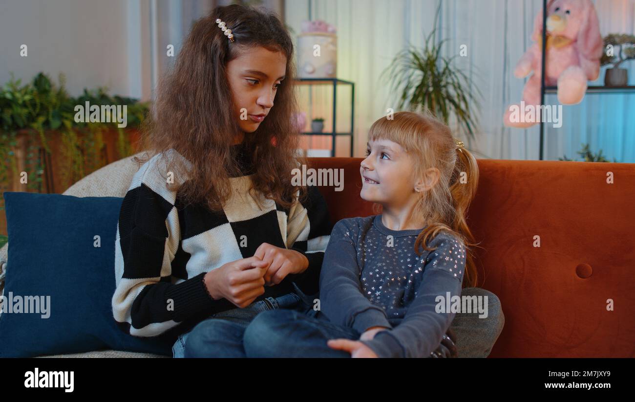 Teenage child and little sister kid chatting talking, make support ...