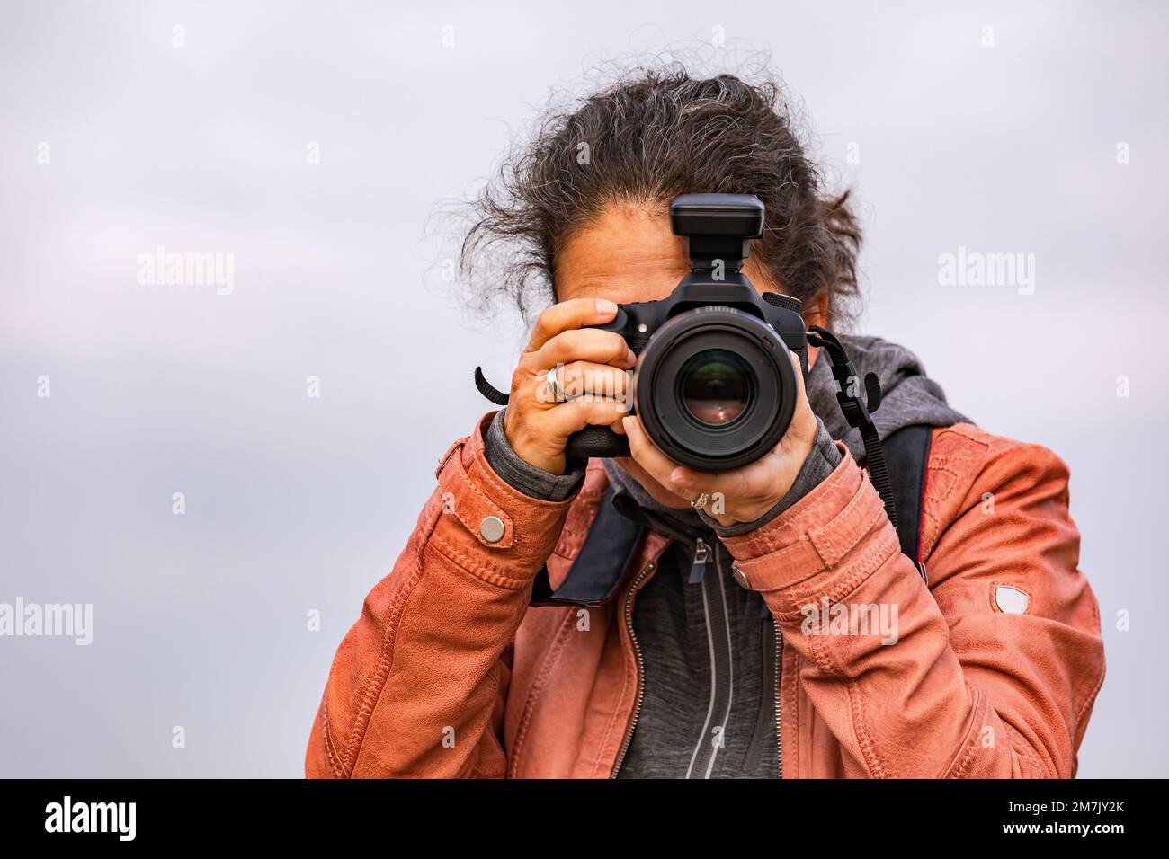 Pretty woman as professional photographer with black camera Stock Photo ...