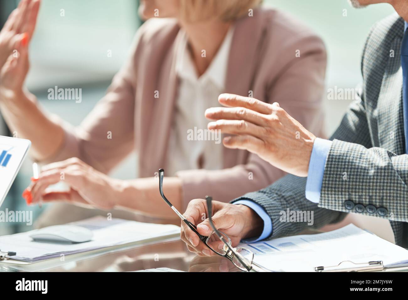 business partners sitting at the office desk Stock Photo - Alamy