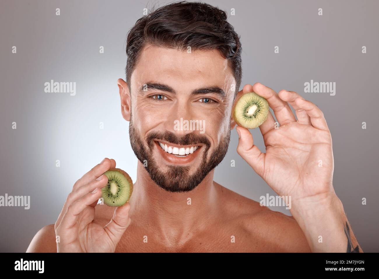 Man, face and beauty with kiwi, facial care with wellness and organic ...