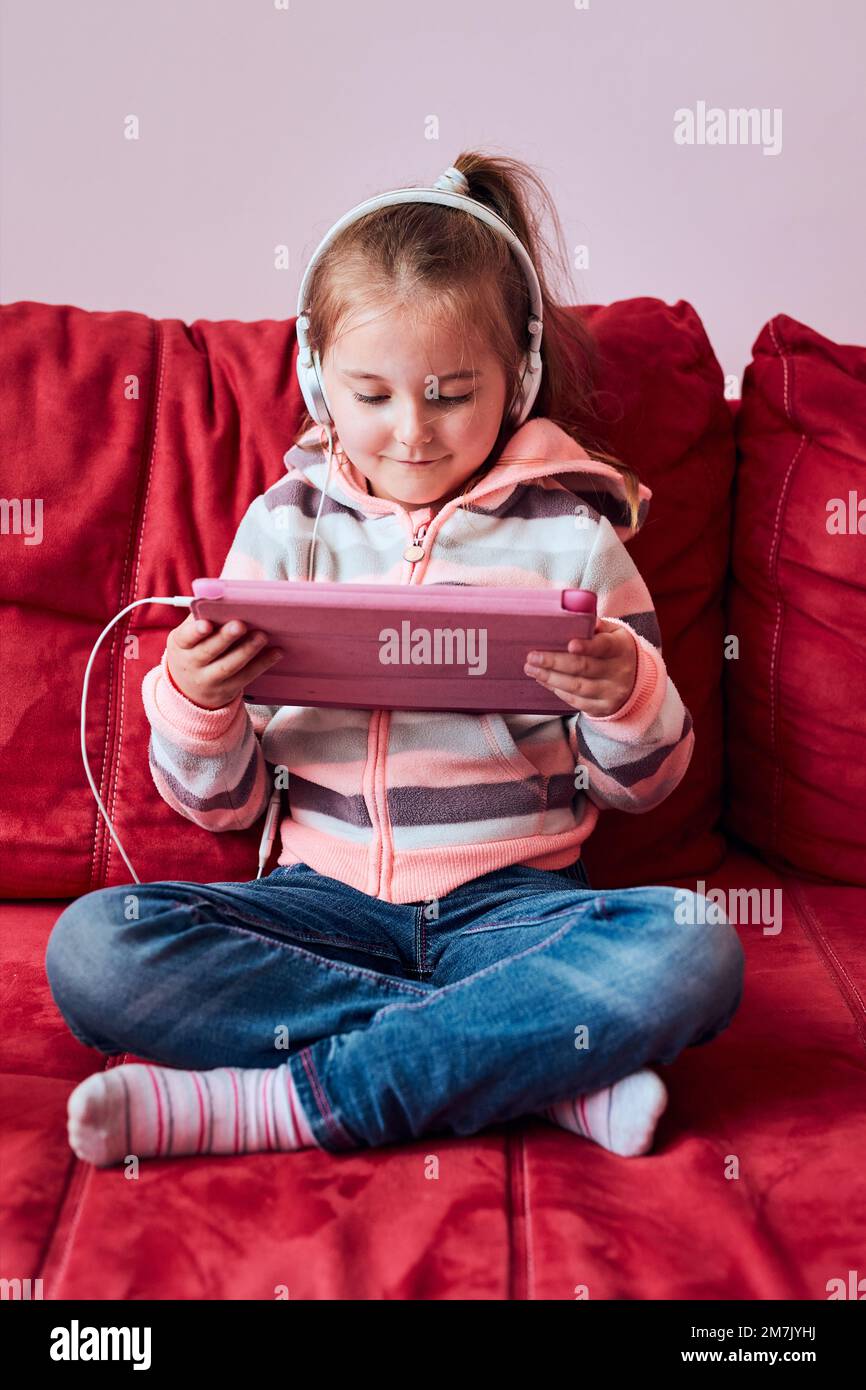Little girl preschooler learning online solving puzzles playing ...
