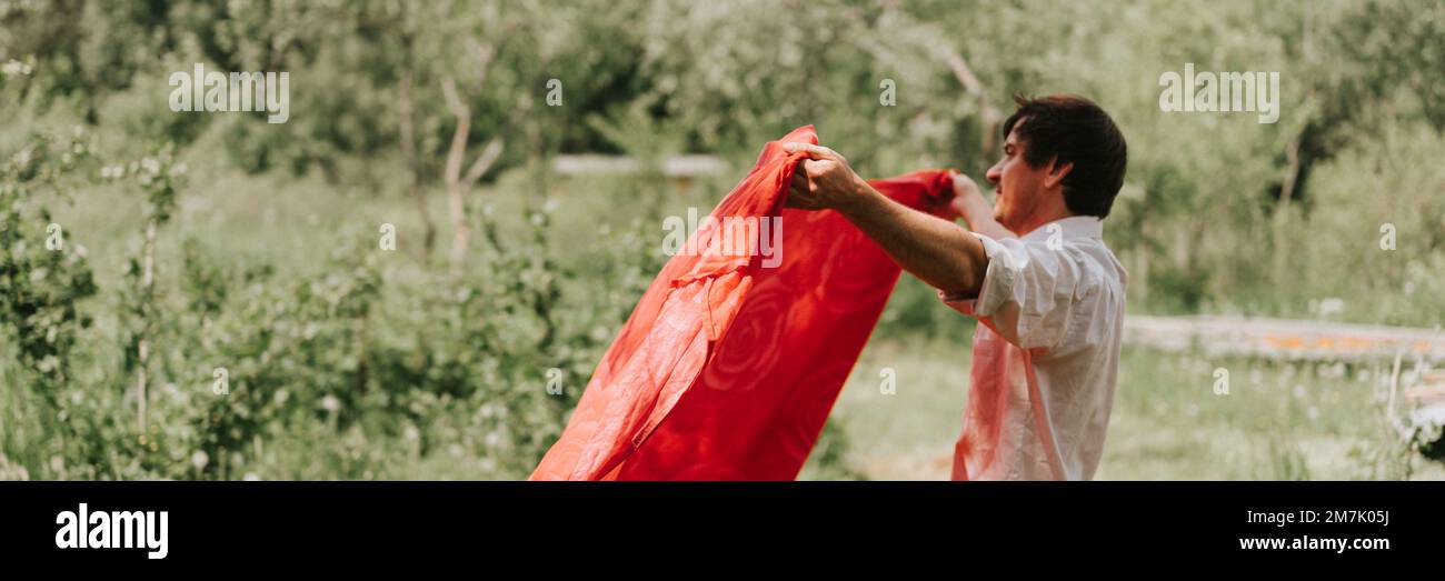 candid young mature choring man chore homework and hanging the laundry ...