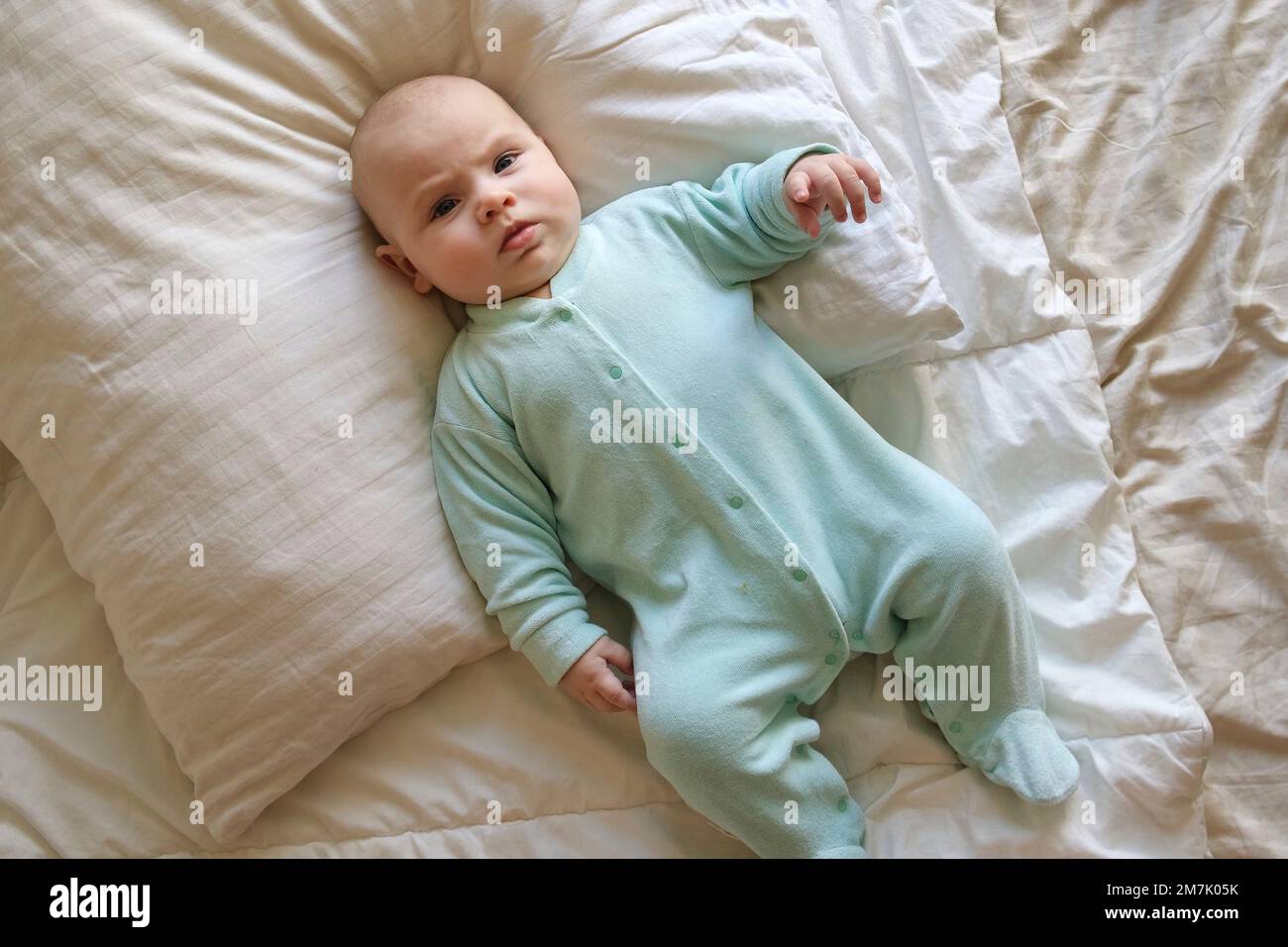 Cute Newborn Baby Lying on the Back in a Child Crib on White. Portrait ...