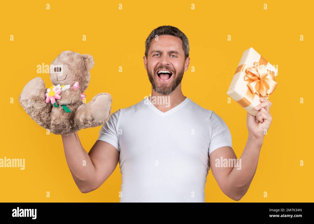 laughing man with present for valentine day. photo of man holding ...