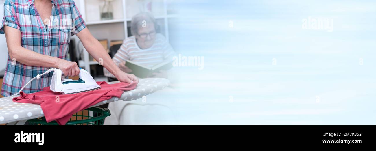 Home helper ironing clothes for elderly woman; panoramic banner Stock ...