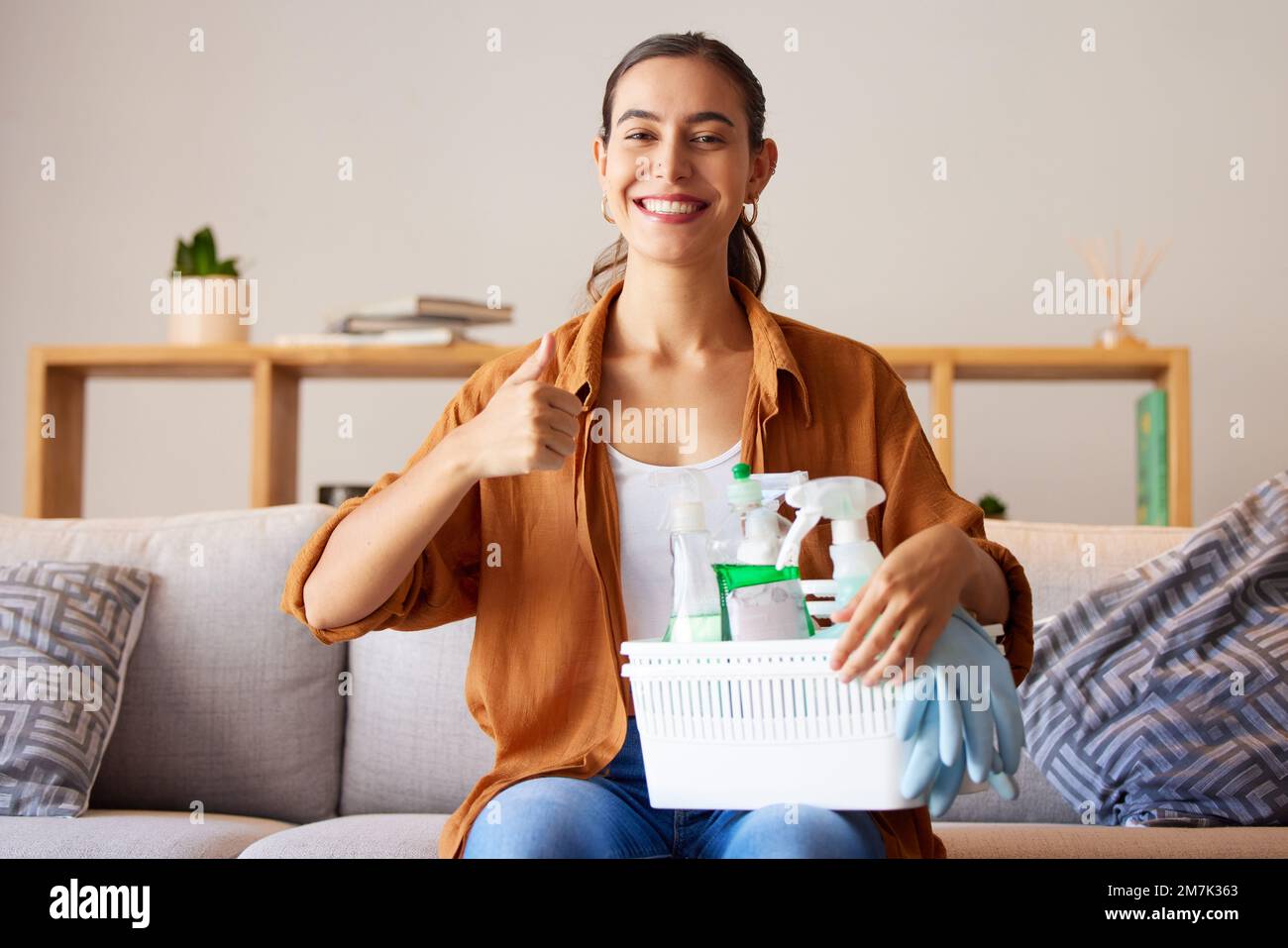 Woman, portrait and thumbs up for home, cleaning and housekeeping with ...