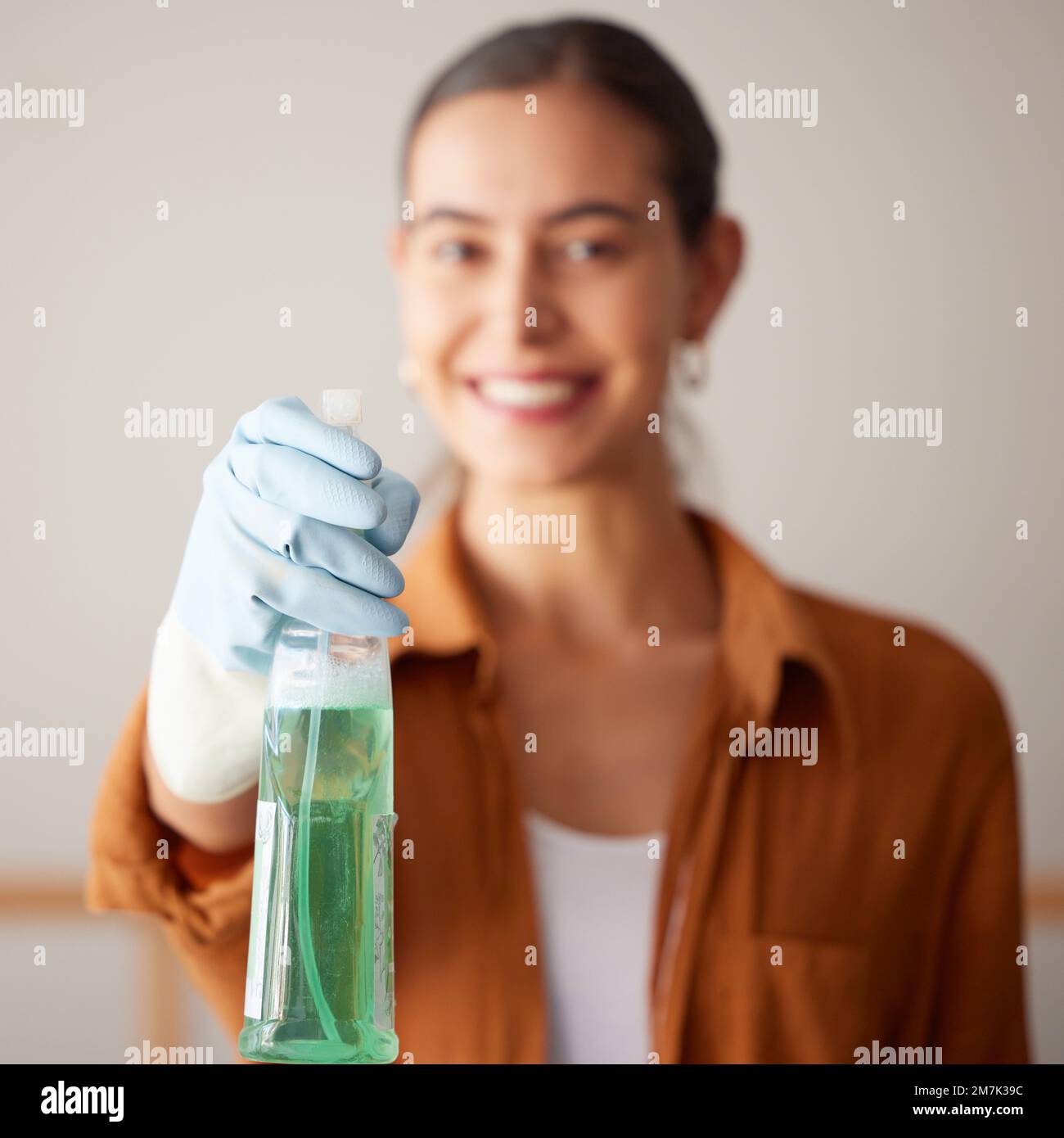 Woman, spray bottle and cleaning service with a smile in a house or ...